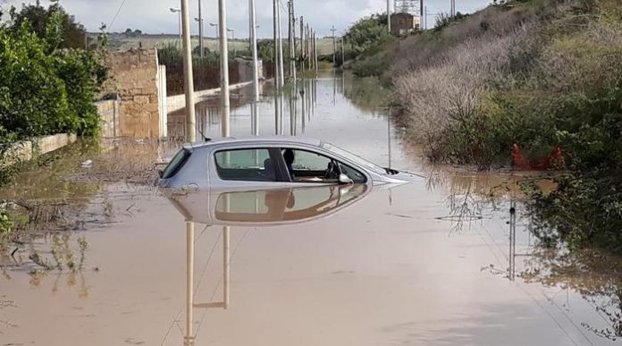 People on Roofs after Storm Floods in Sicily, Italy
